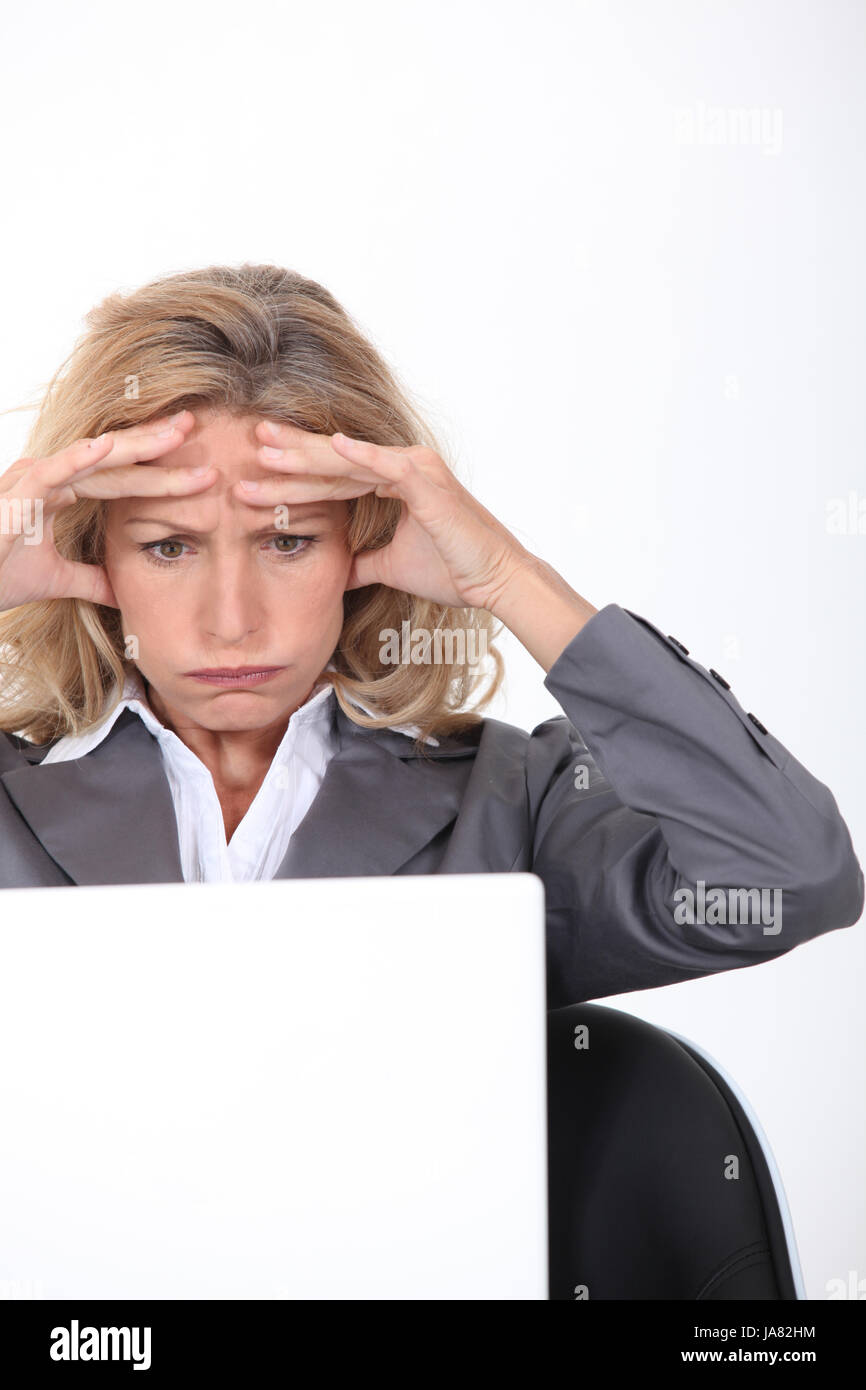 Woman pulling face and desk hi-res stock photography and images - Alamy