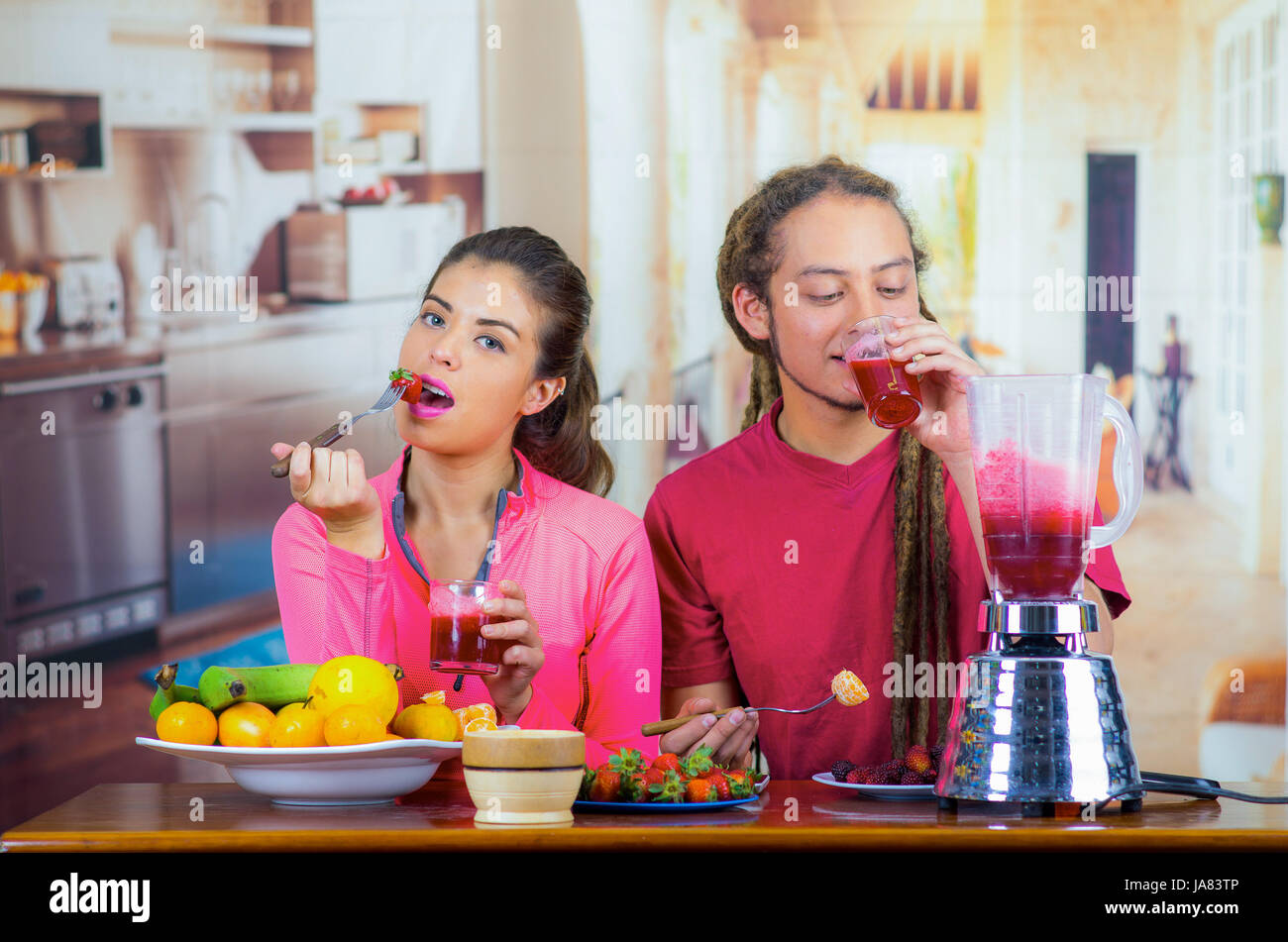 Hispanic young healthy couple enjoying breakfast together, sharing ...