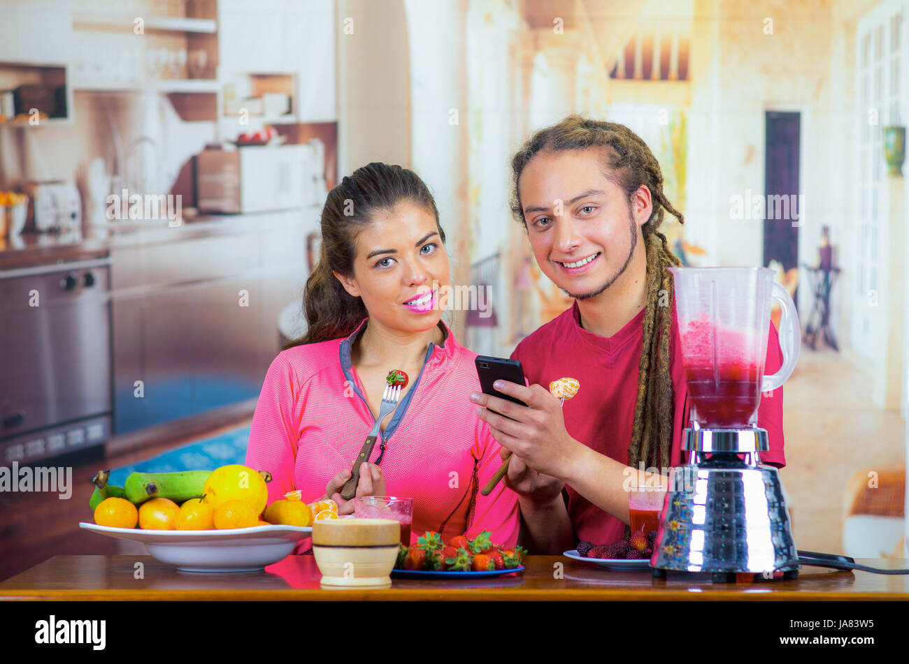 Hispanic young healthy couple enjoying breakfast together, sharing ...