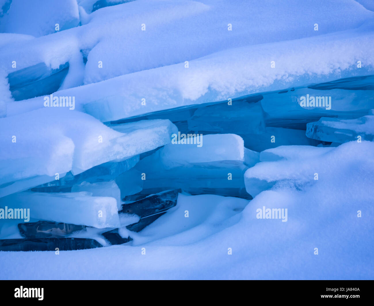 Ice blocks covered with snow at Frozen Lake Baikal, Russia Stock Photo ...