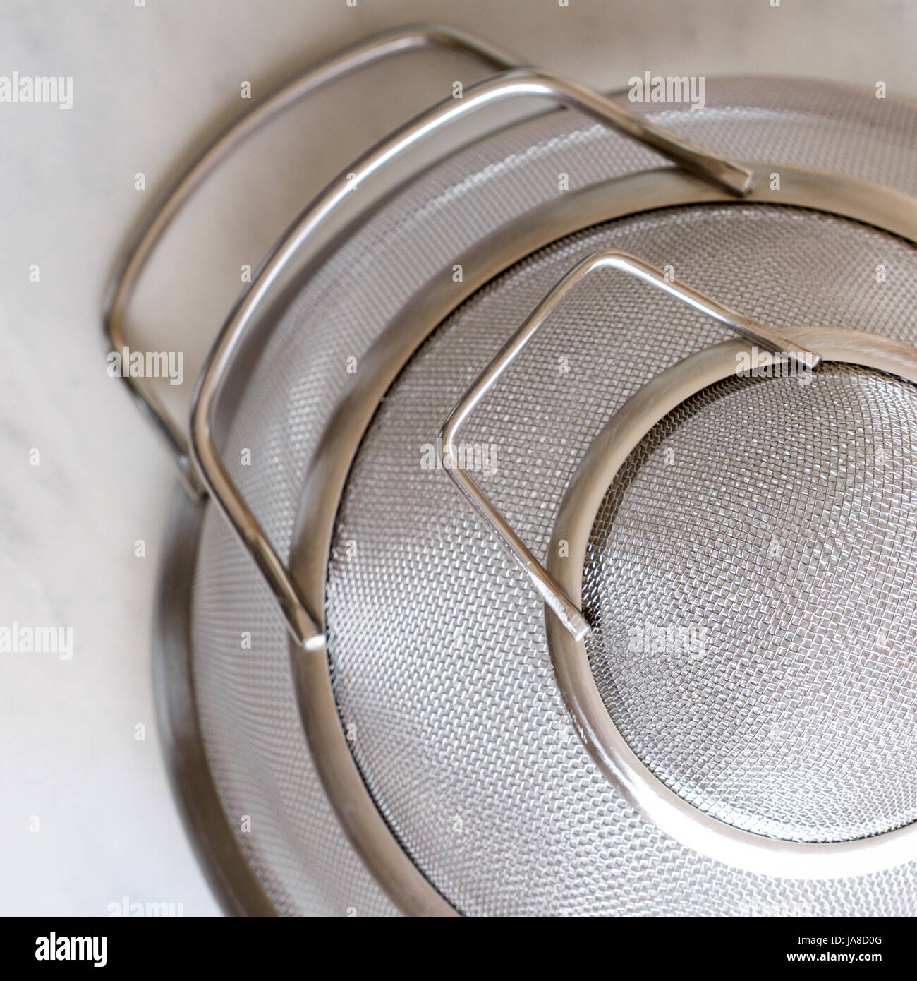 Three metal kitchen sieves Stock Photo - Alamy