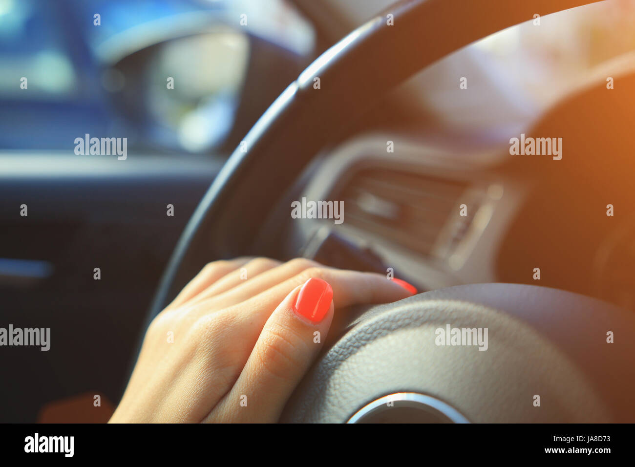 Woman driving background. Fingers with pink vivid nails on steering ...