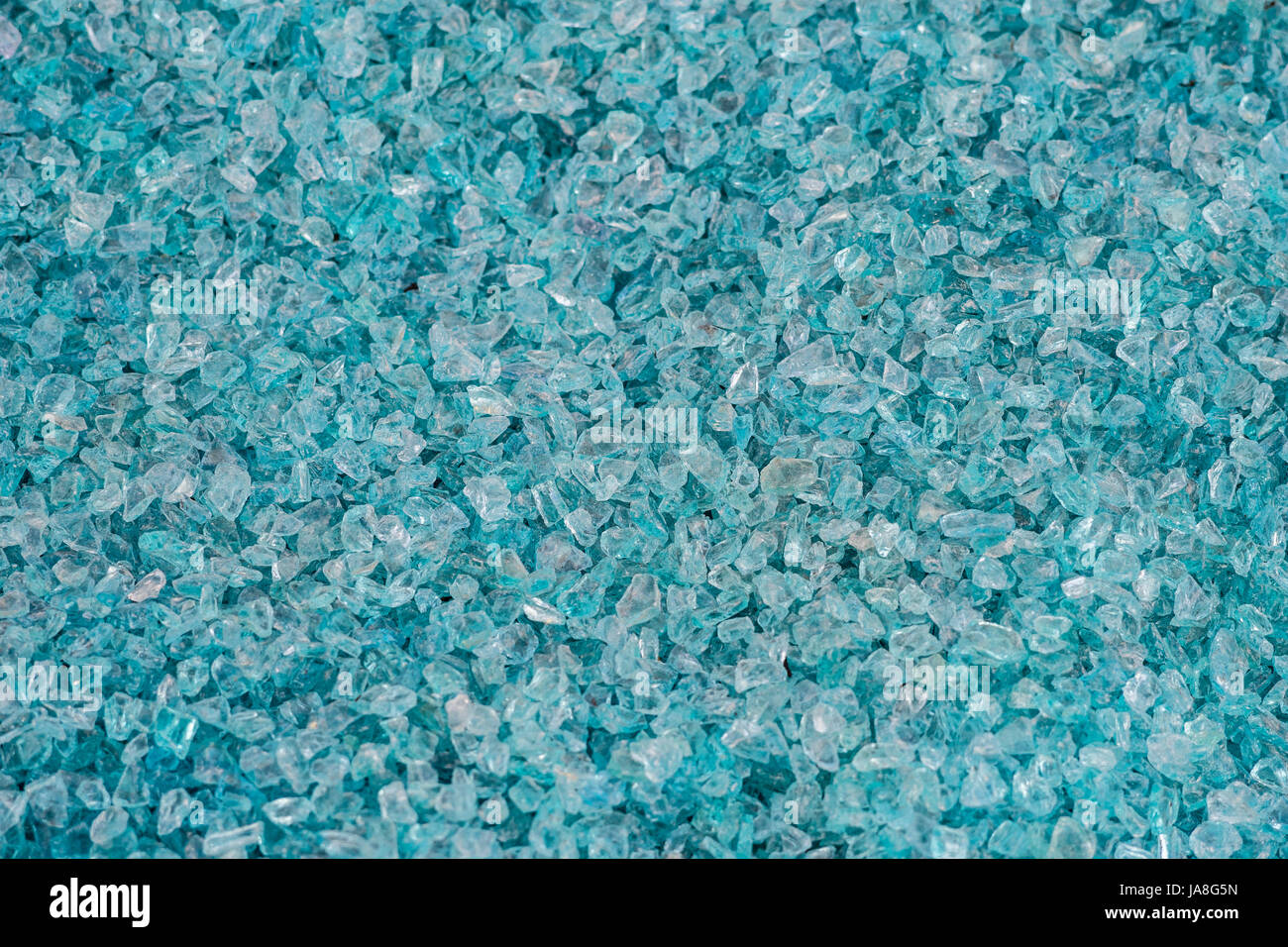 Background of decorative broken bits of blue color glass. Selective ...