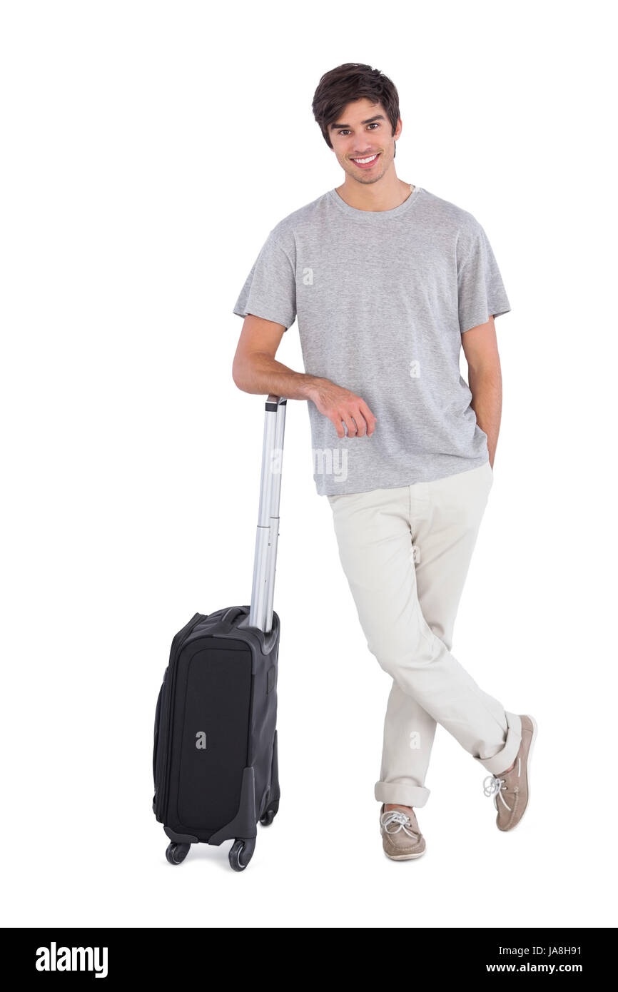 Standing man with his suitcase on a white background Stock Photo - Alamy