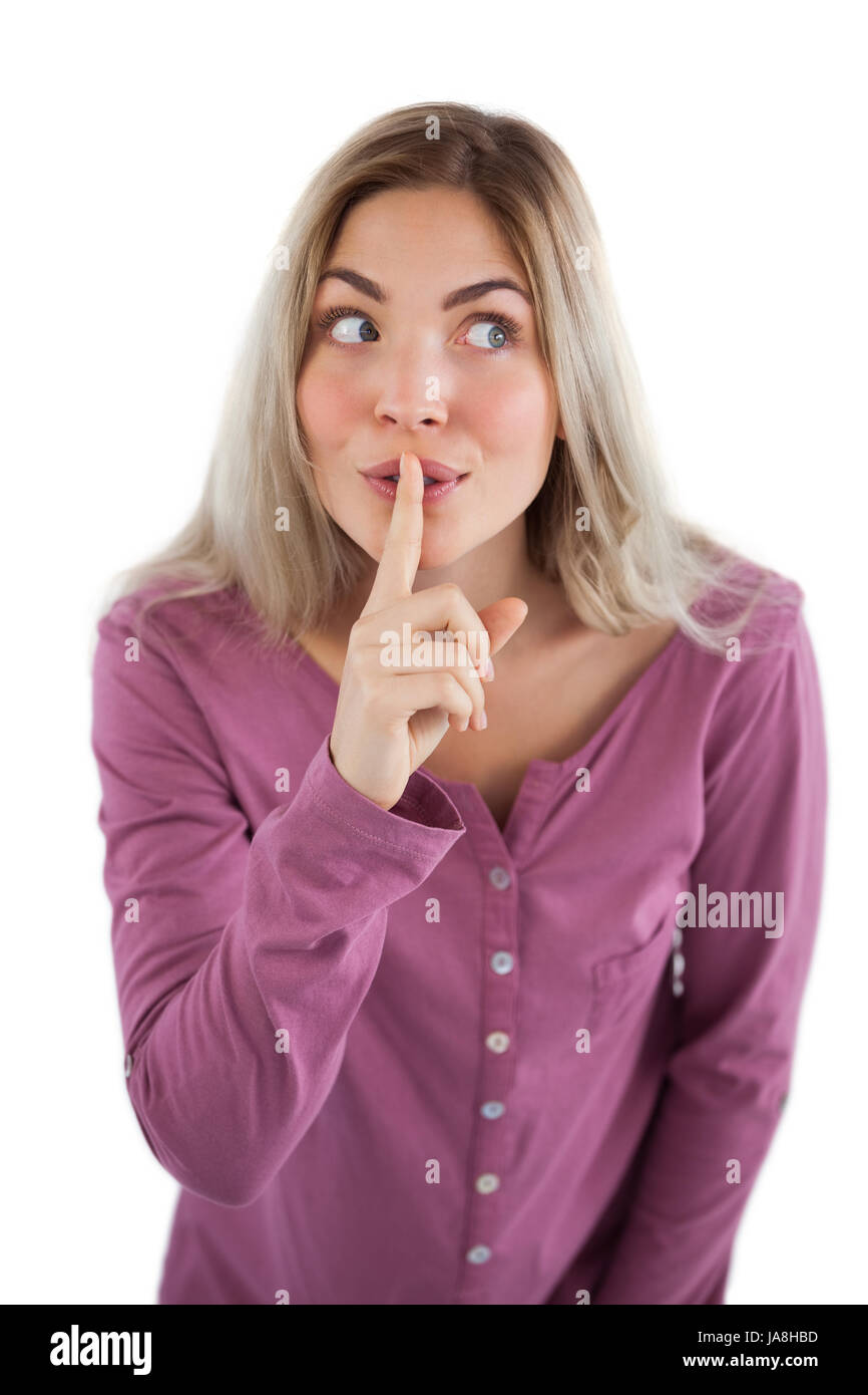 Woman saying to be quiet with finger on lips Stock Photo - Alamy