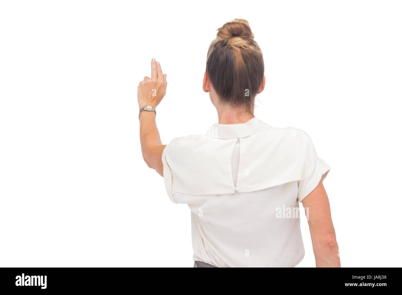 Businesswoman touching something with hand rear view Stock Photo - Alamy