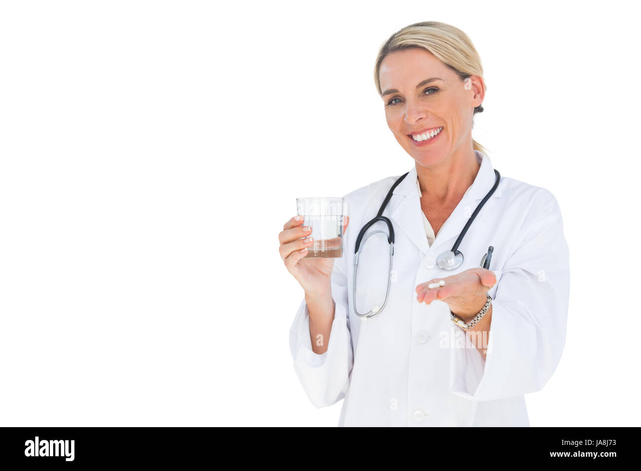Happy doctor holding out pills and water glass on white background ...