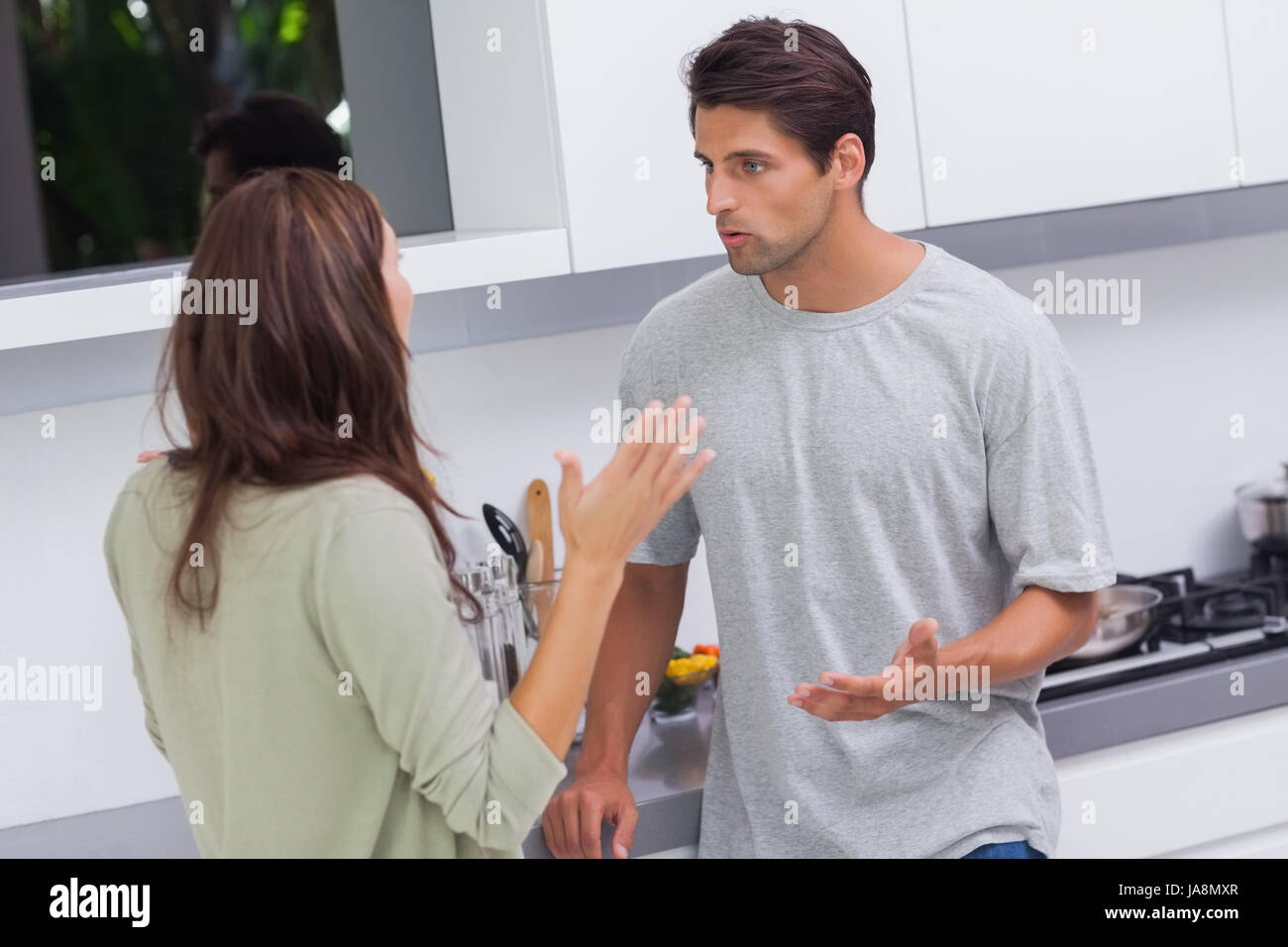 Young couple arguing in the kitchen Stock Photo - Alamy