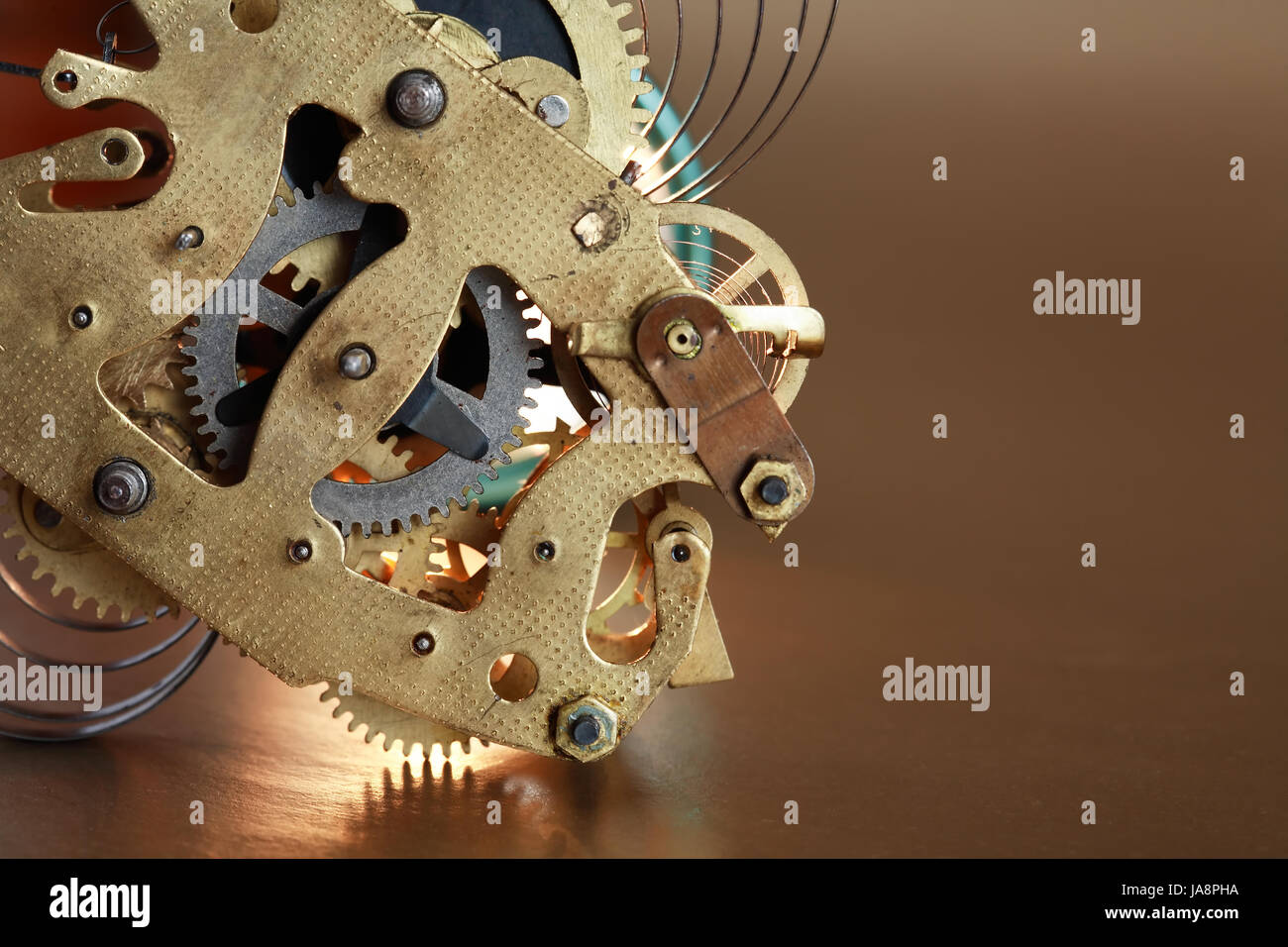 Closeup of old clock mechanism on brown background with free space for ...