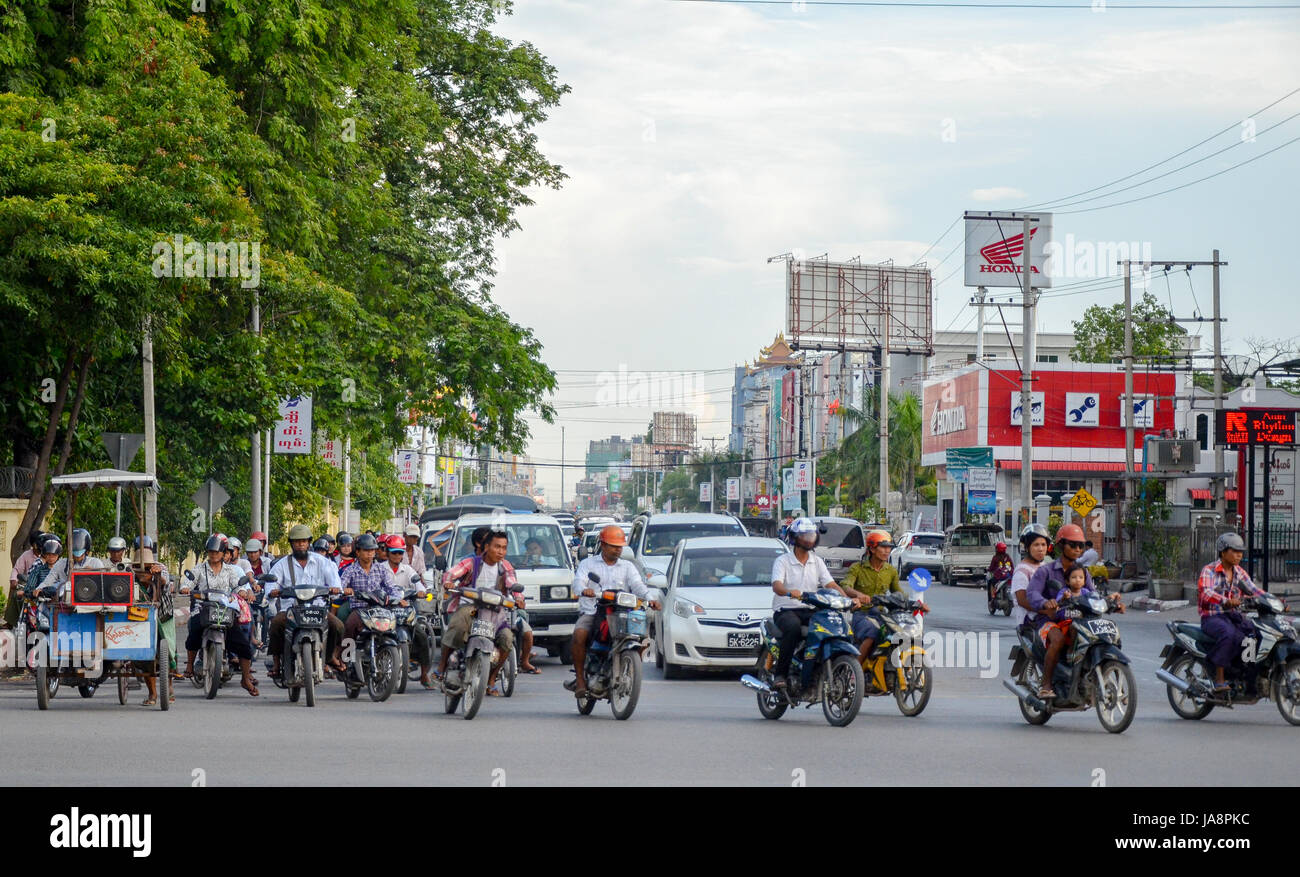 Asia, Myanmar (Burma): Motorbike traffic at an intersection in Mandalay ...