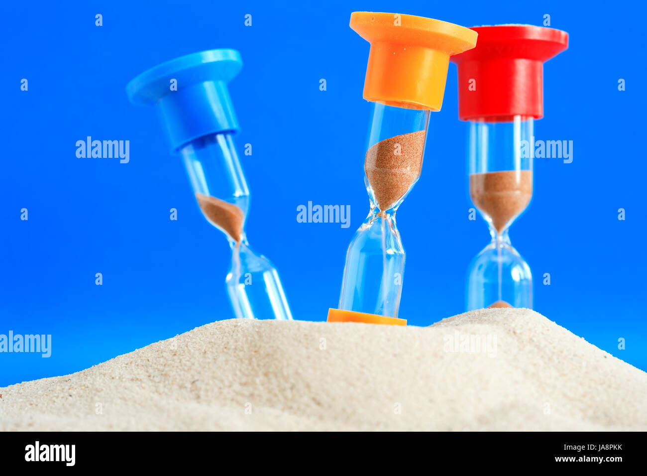 Three glass hourglasses hi-res stock photography and images - Alamy