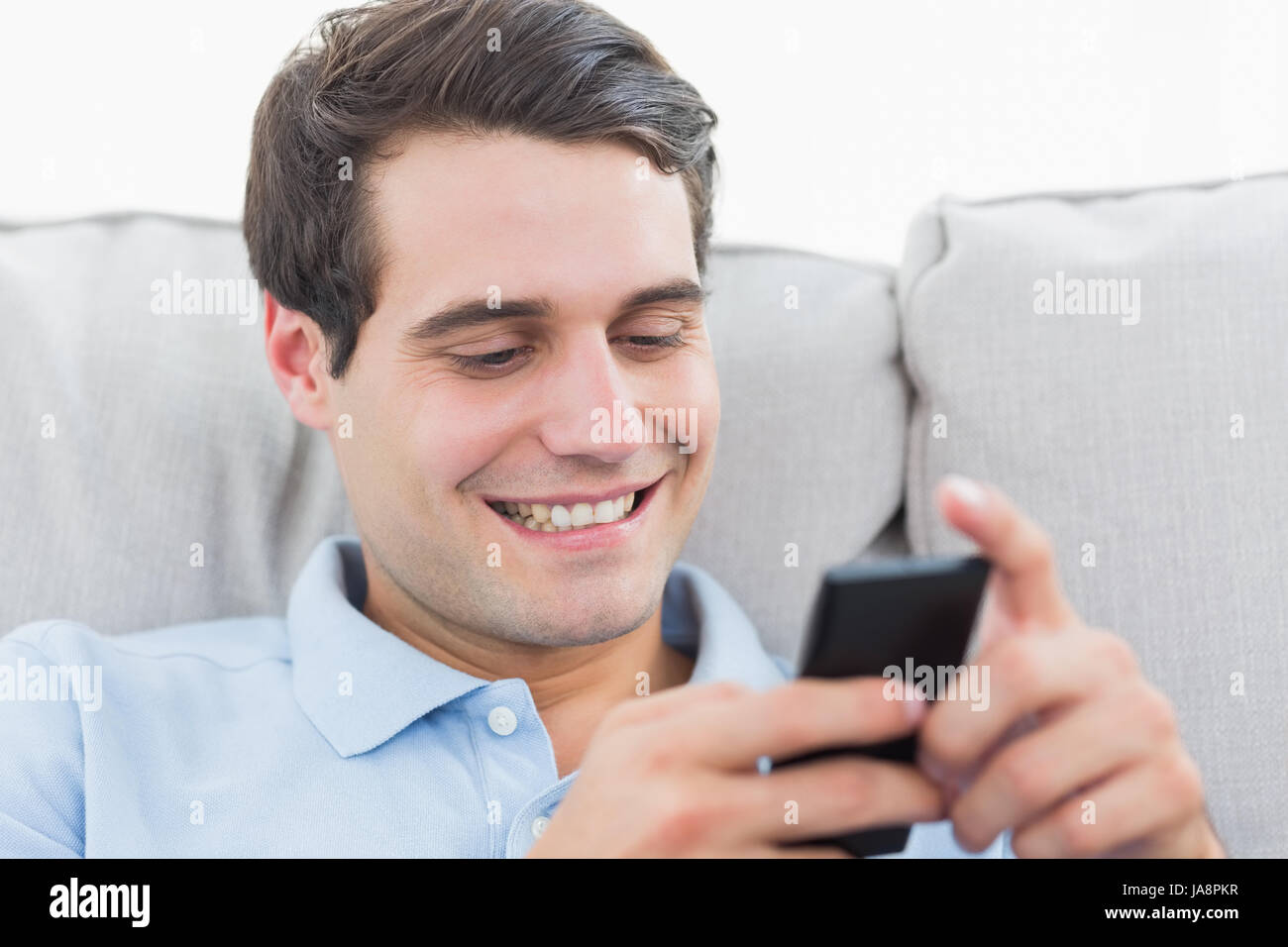 Sat on sofa with phone hi-res stock photography and images - Alamy