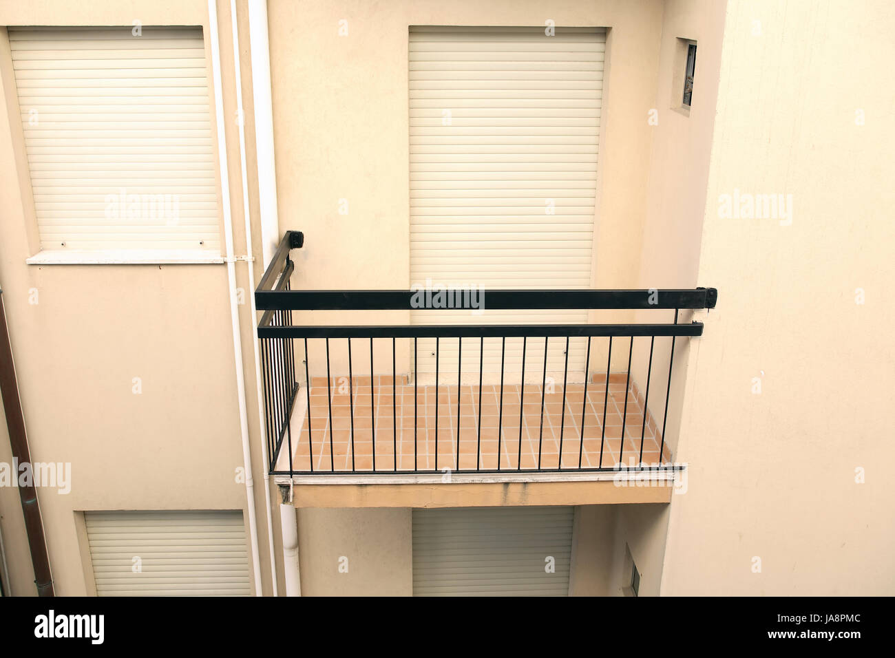 Closeup of small empty balcony with closed window and door Stock Photo ...