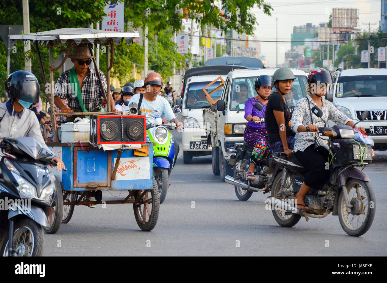Asia, Myanmar (Burma): Motorbike traffic at an intersection in Mandalay ...