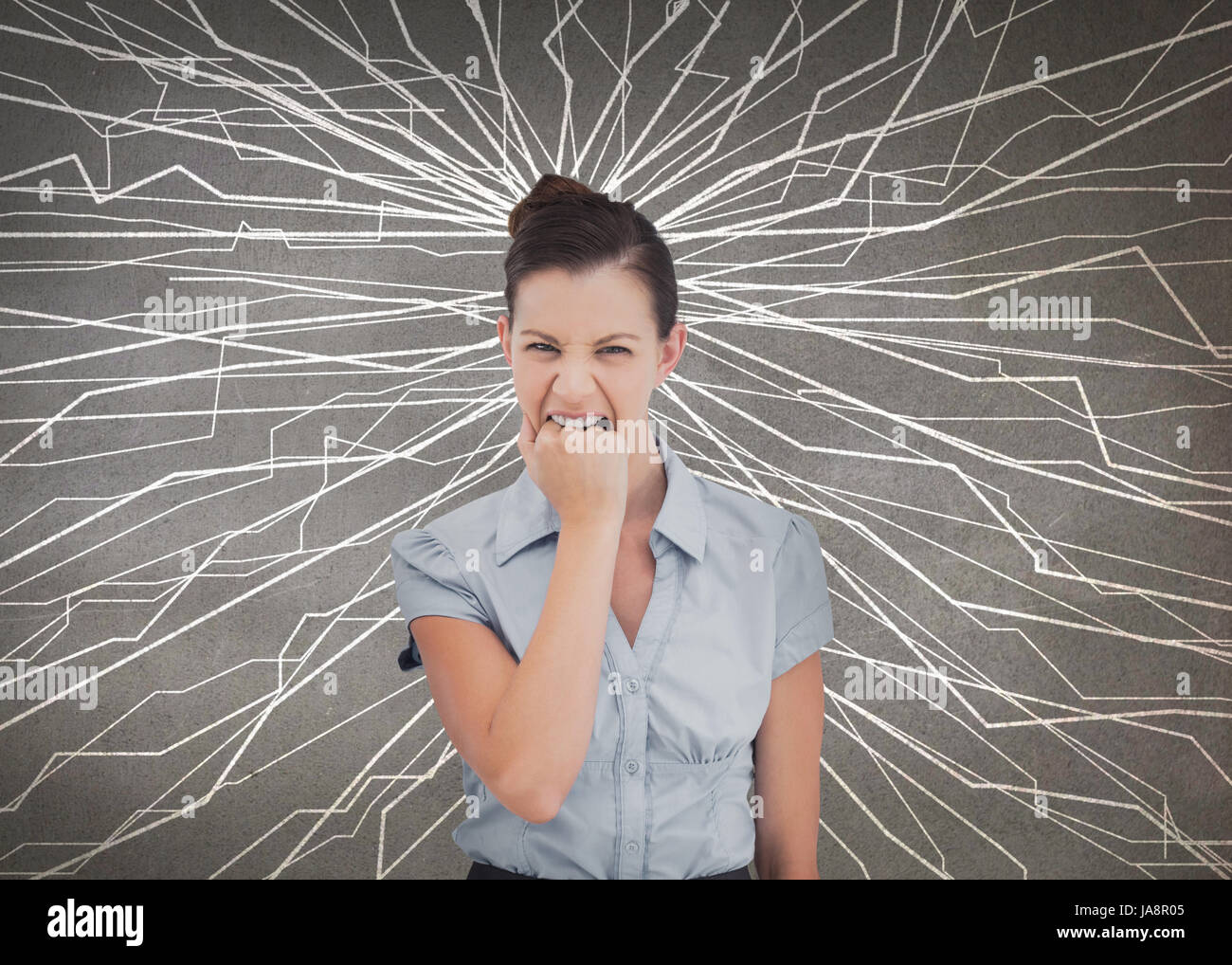 Furious businesswoman biting her fist Stock Photo - Alamy