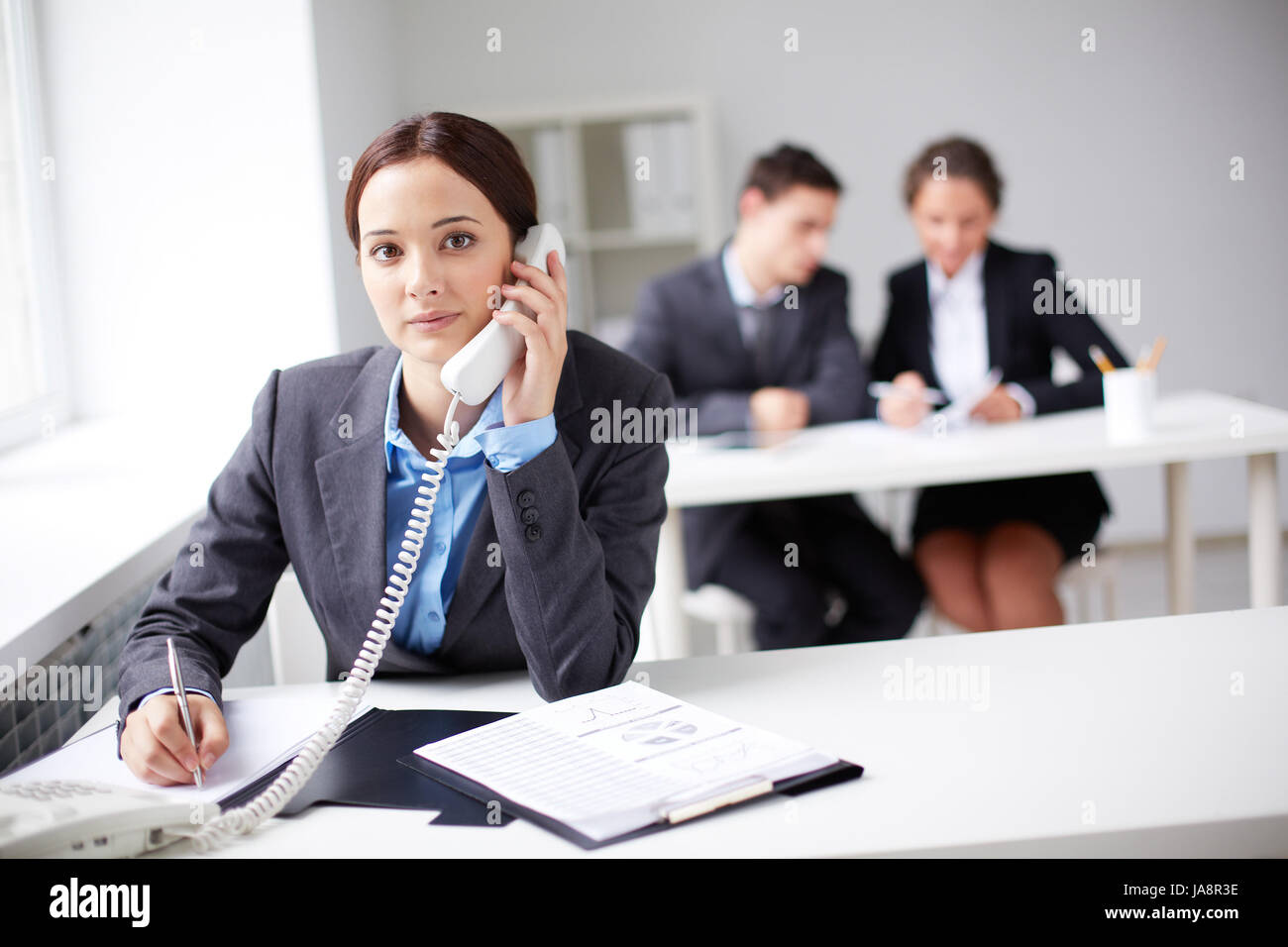 Portrait of smart businesswoman calling on the phone on background of ...