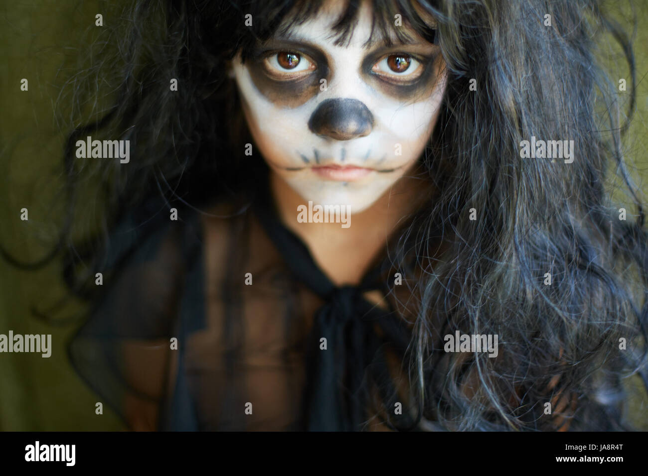 Portrait of spooky girl in Halloween attire looking at camera Stock ...