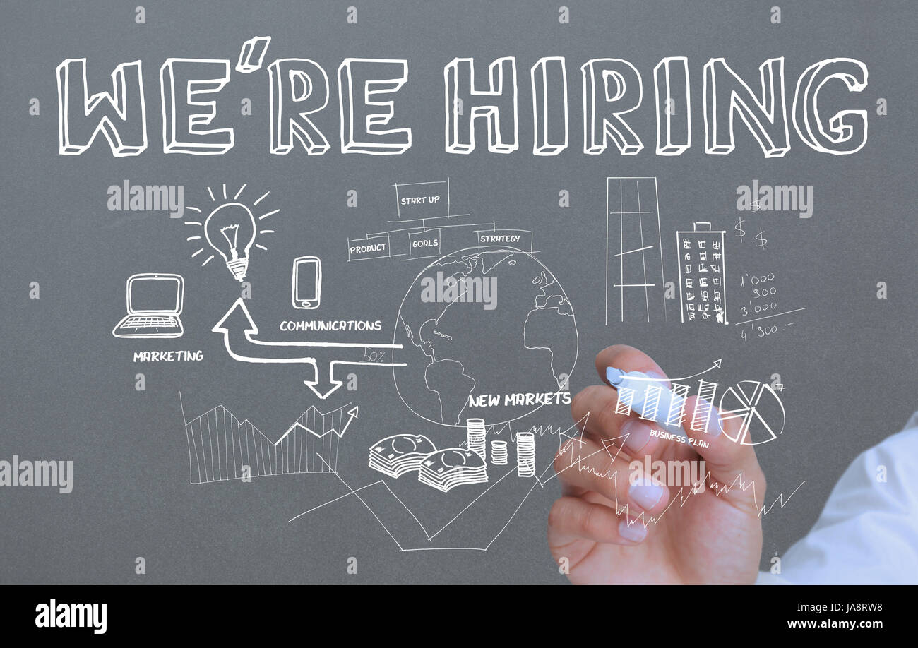Businessman writing we are hiring with a marker on grey background ...