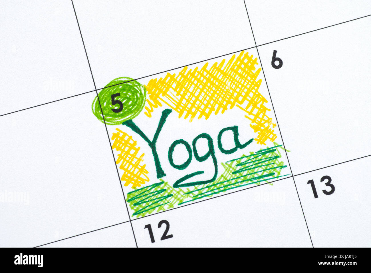 Reminder Yoga in calendar. Close-up Stock Photo - Alamy