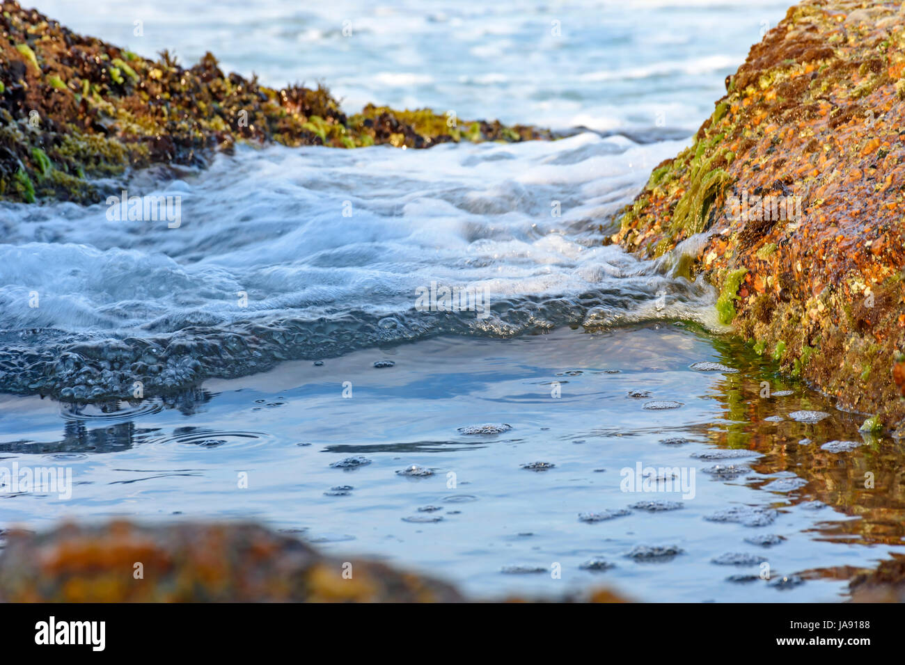 Water dripping between rocks during sunset Stock Photo - Alamy