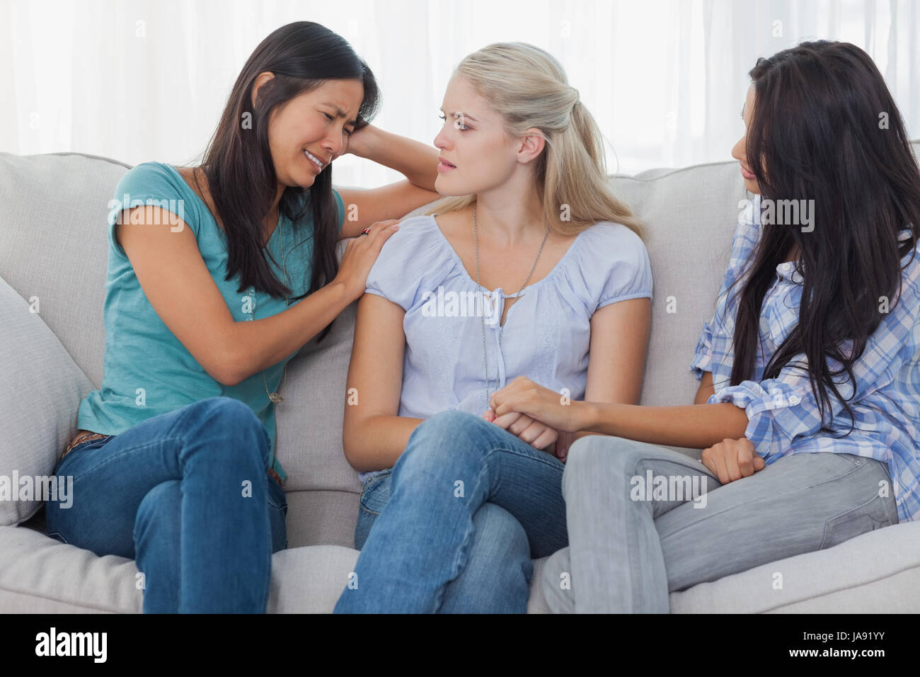 Asian friend crying friend comforting hi-res stock photography and ...