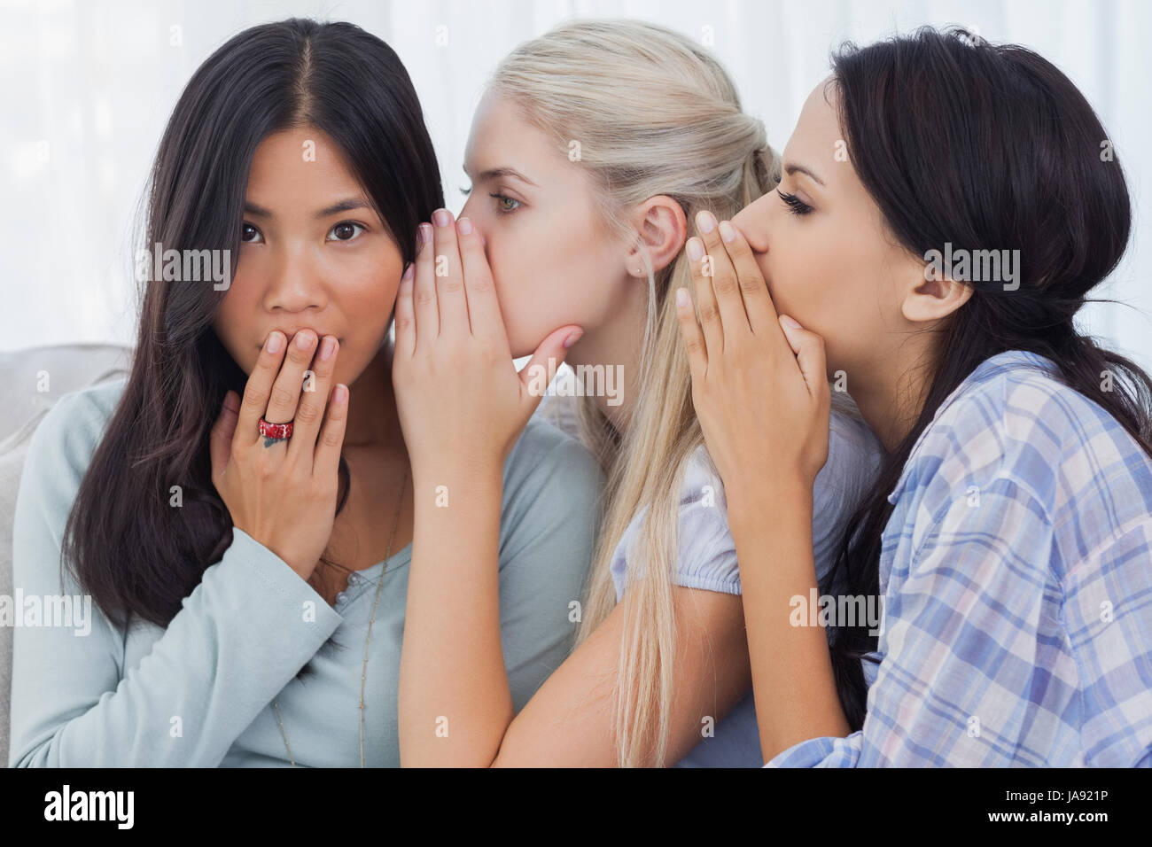 Telling secrets blonde woman hi-res stock photography and images - Alamy