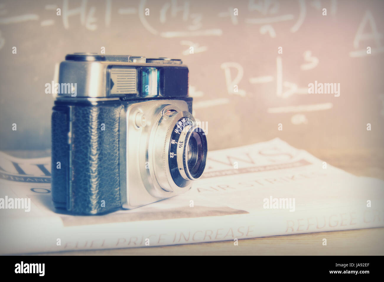 Old vintage retro camera with mocked up daily newspaper Stock Photo - Alamy