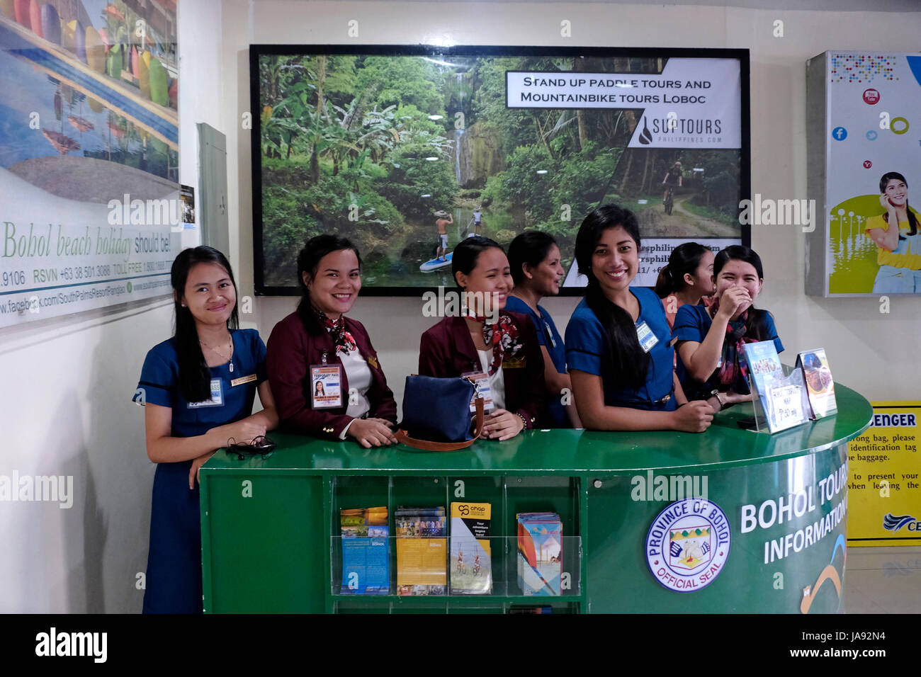 Representative of the local tourism office wait for passengers at the ...