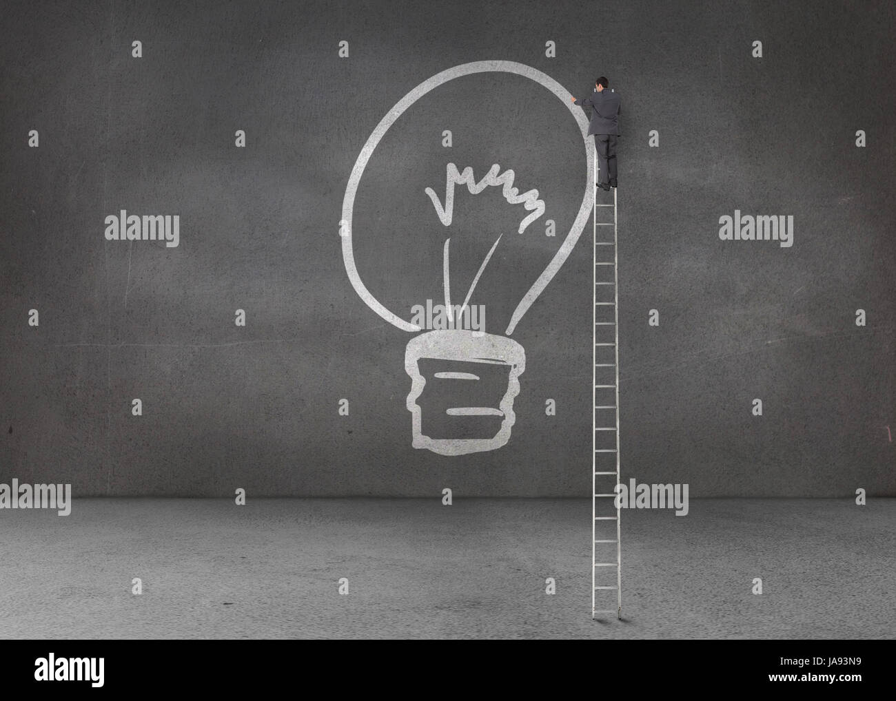 Businessman drawing a light bulb in an empty dark room Stock Photo - Alamy