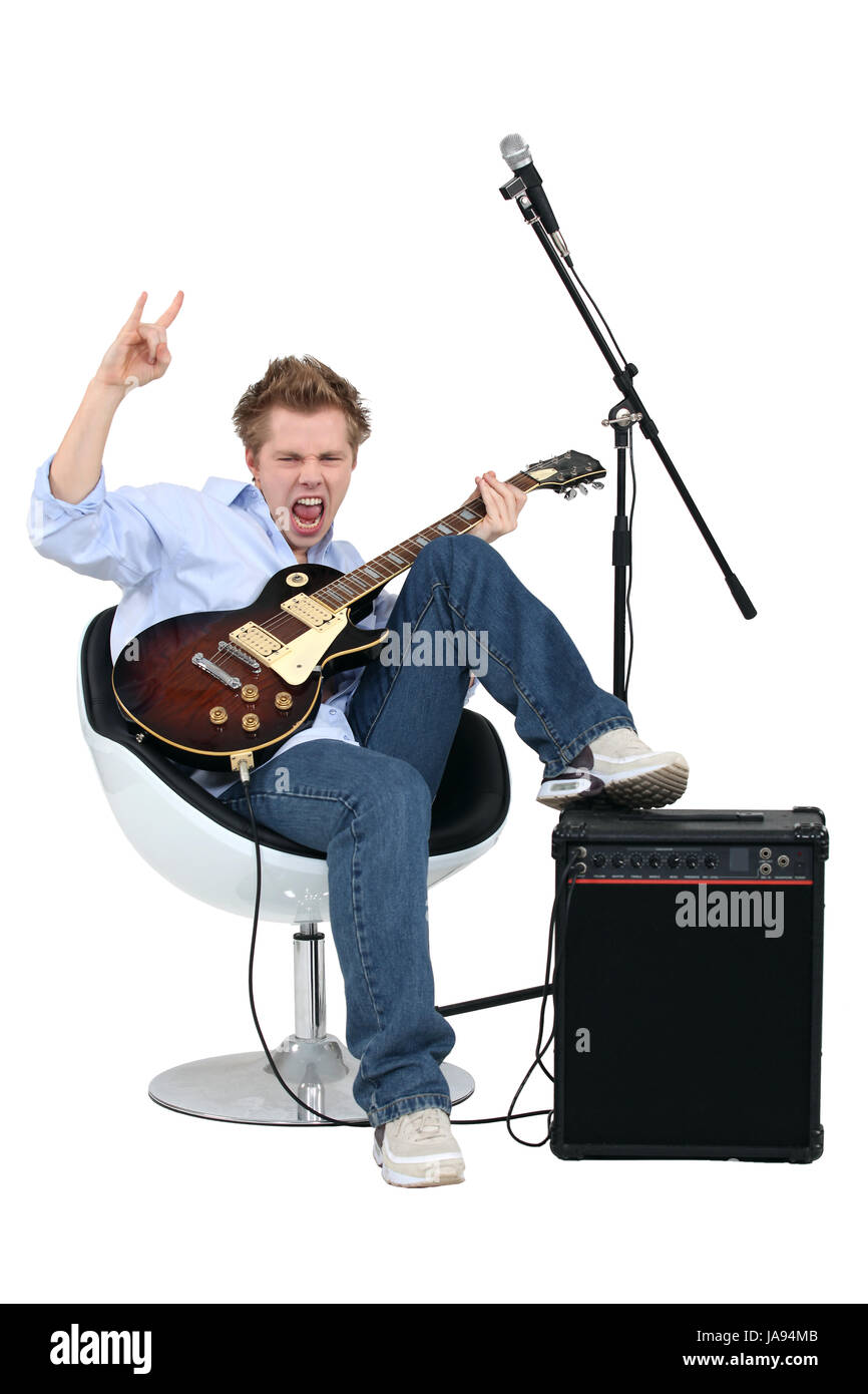 Young man with guitar playing rock music Stock Photo - Alamy
