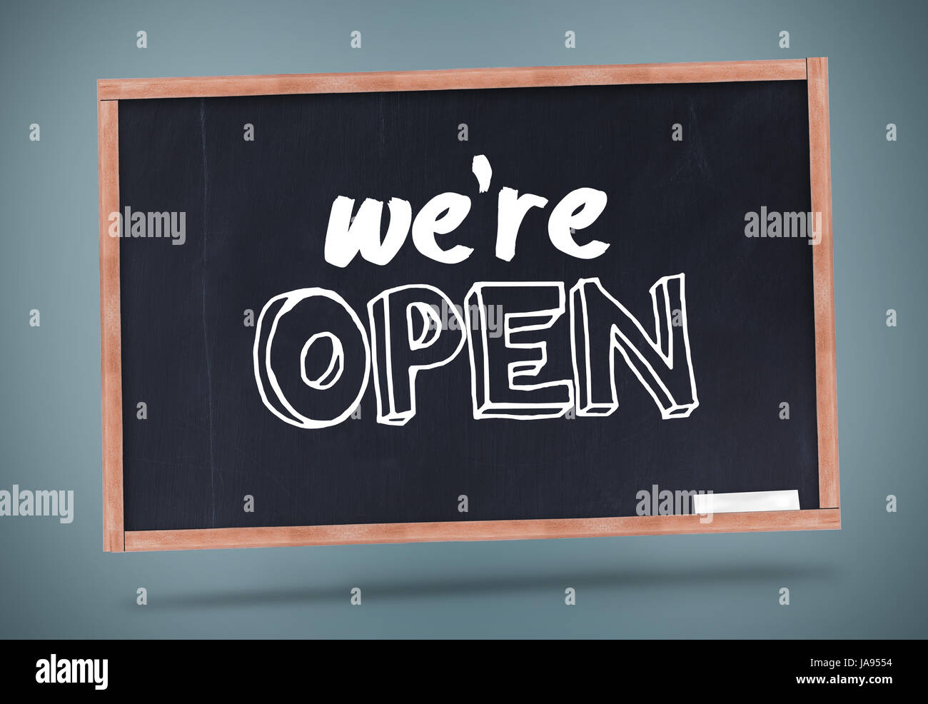 We are open written on chalkboard against grey background Stock Photo ...