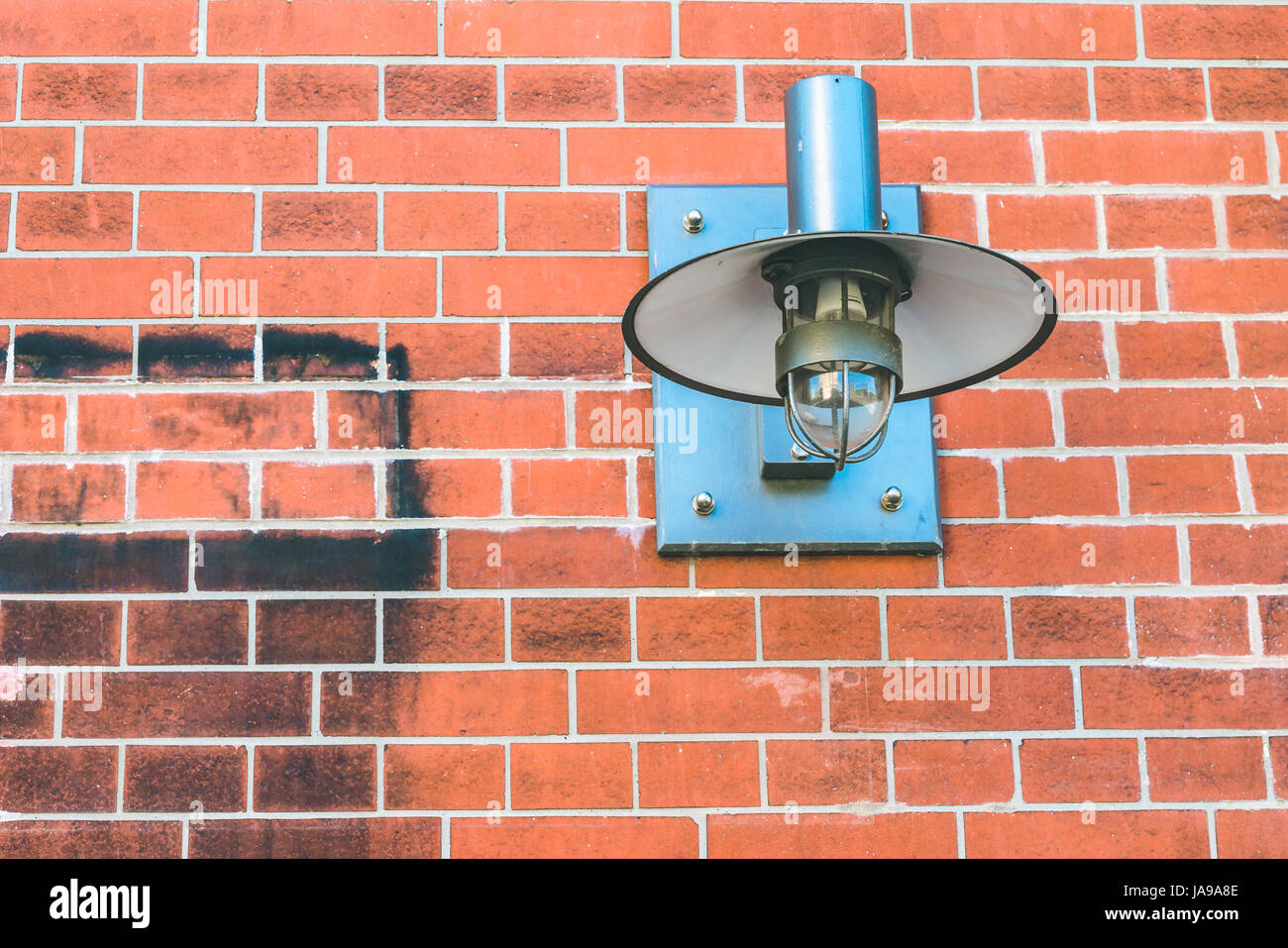 Metall lamp fixed on a brick wall Stock Photo - Alamy