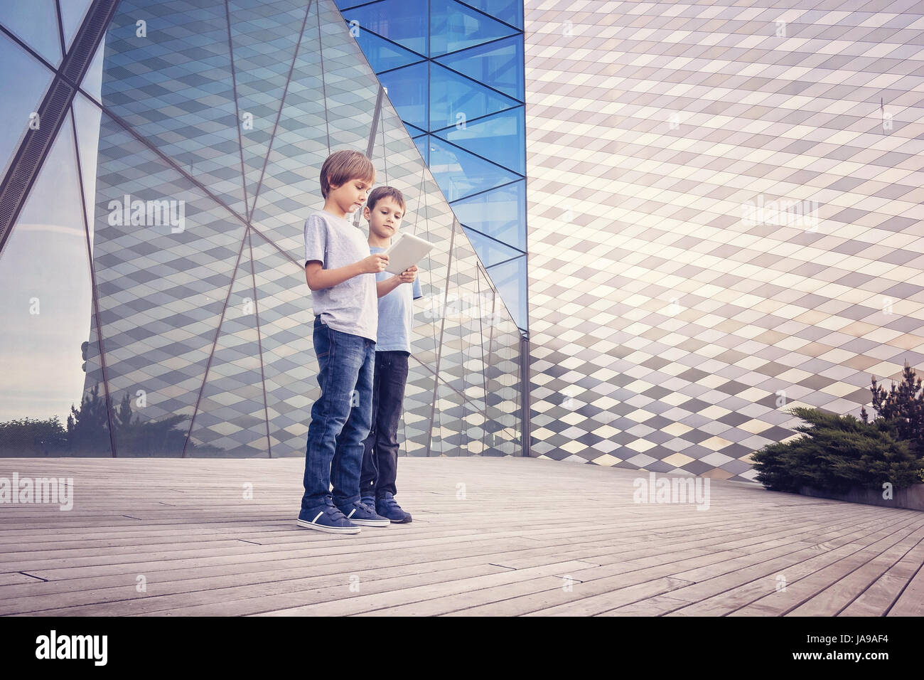 Children with tablet computers in the city Stock Photo - Alamy