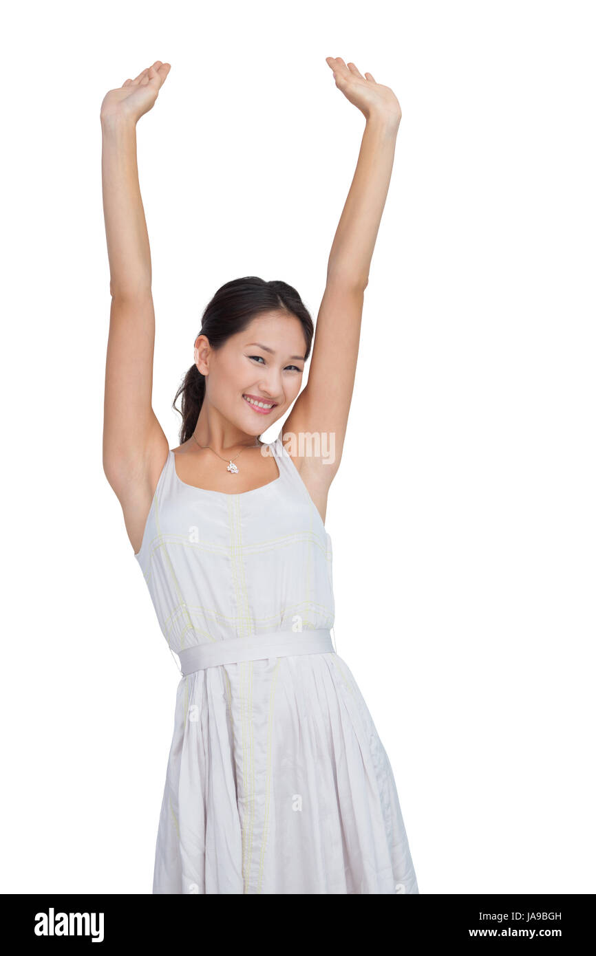 Beautiful woman cheering and looking at camera on white background ...
