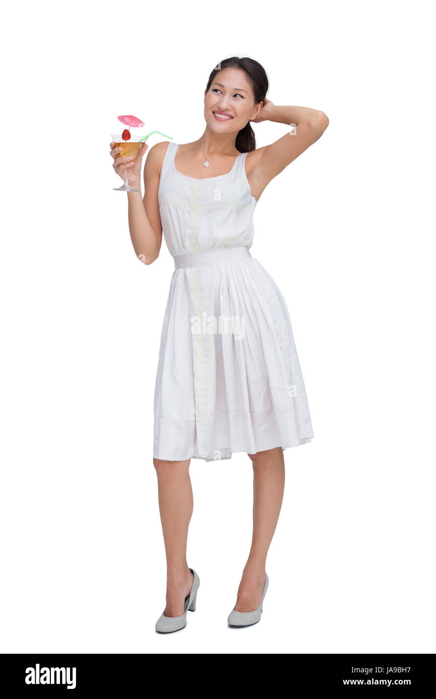 Cheerful brunette posing with cocktail against white background Stock ...