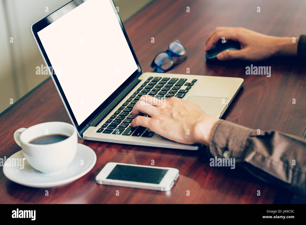Business man hand using computer laptop in the office with sunlight ...