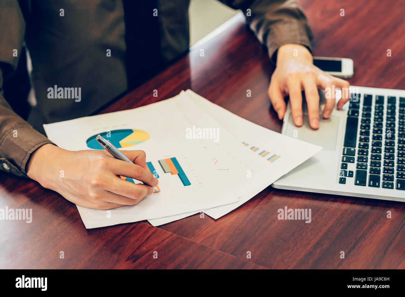 Young business man hand writing paper in the office with sunlight ...