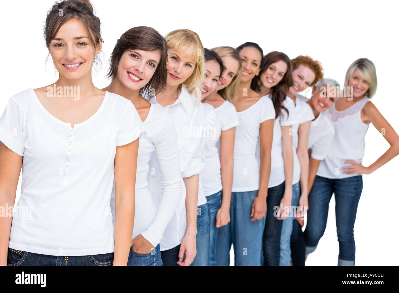 Cheerful casual models posing in a line looking at camera on white ...