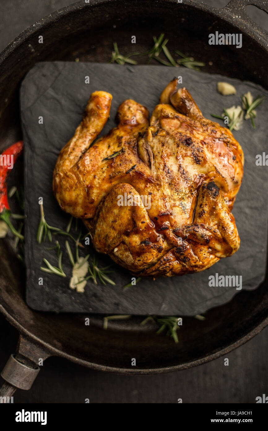 Whole raw corn chicken on dark pan. Restaurant. Top view Stock Photo ...