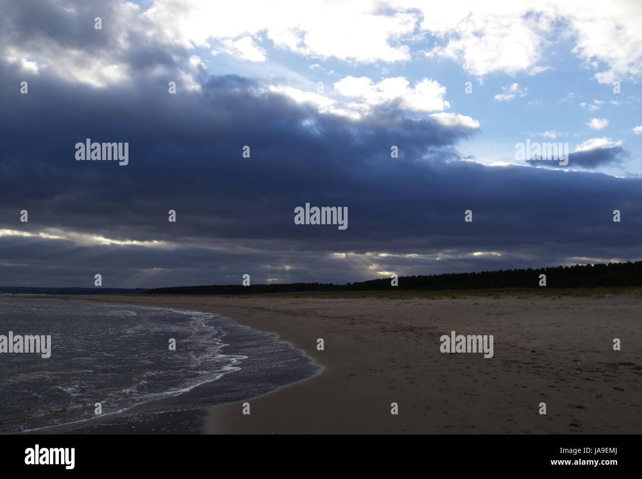 Atmospheric moody beach and clouds Stock Photo - Alamy