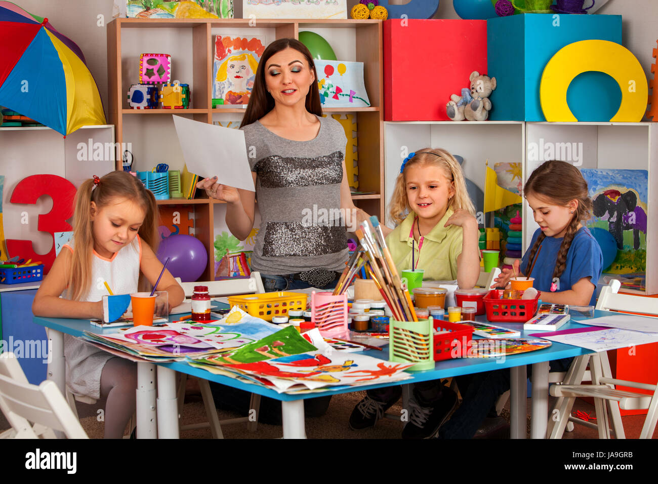 Children painting and drawing together . Craft lesson in primary school ...