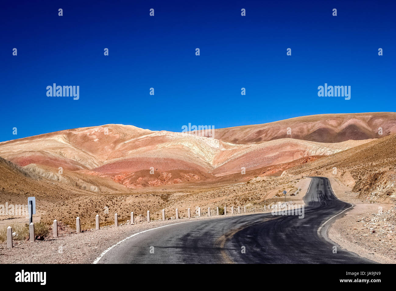Empty road through dry, cactus ridden landscape in the northern part of ...