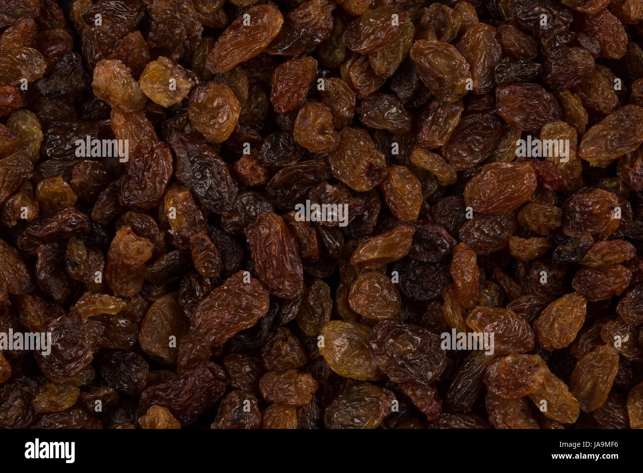 Sweet dry raisins close up shot for background Stock Photo - Alamy