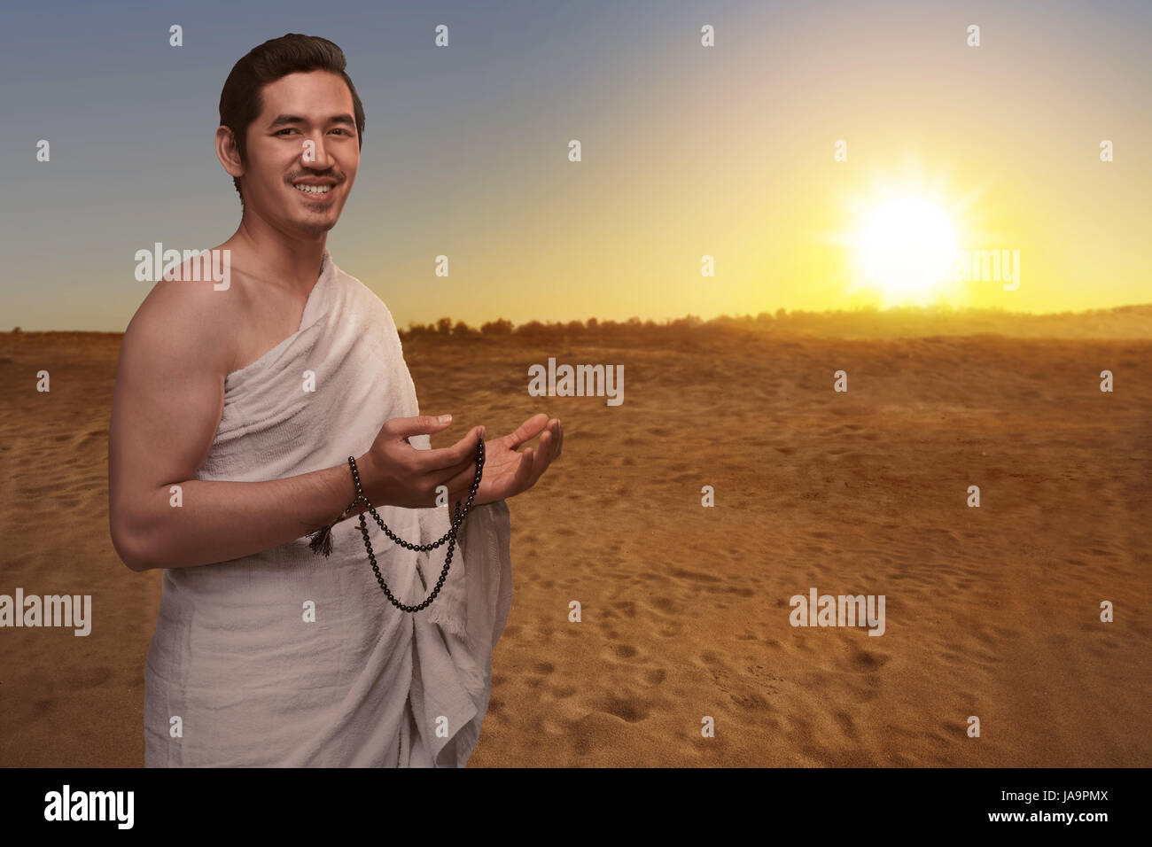 Handsome asian muslim man in ihram dress with prayer beads ready for ...