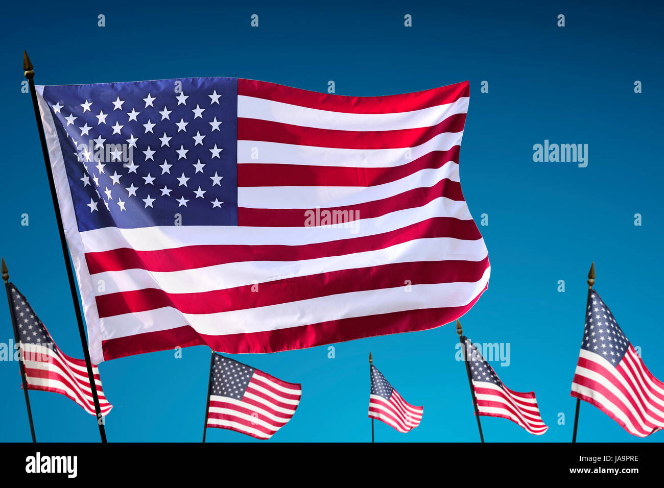 American Flag hanging on the pole flutter against blue background Stock ...