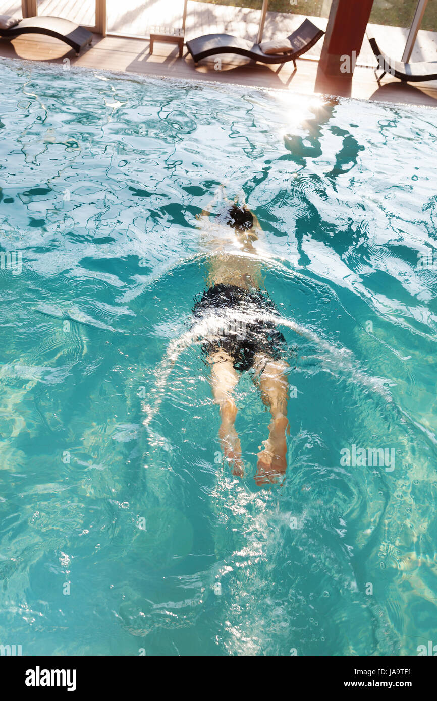 Young man underwater in wellness swimming pool. Relax and wellness ...