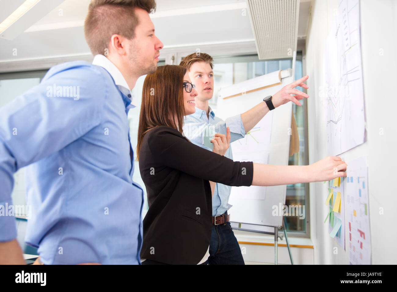 Business people discussing over graph hi-res stock photography and ...