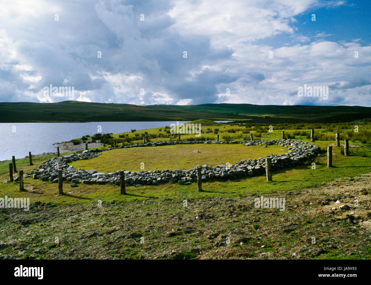 View NNW of a reconstructed Bronze Age ring cairn (44) with round ...