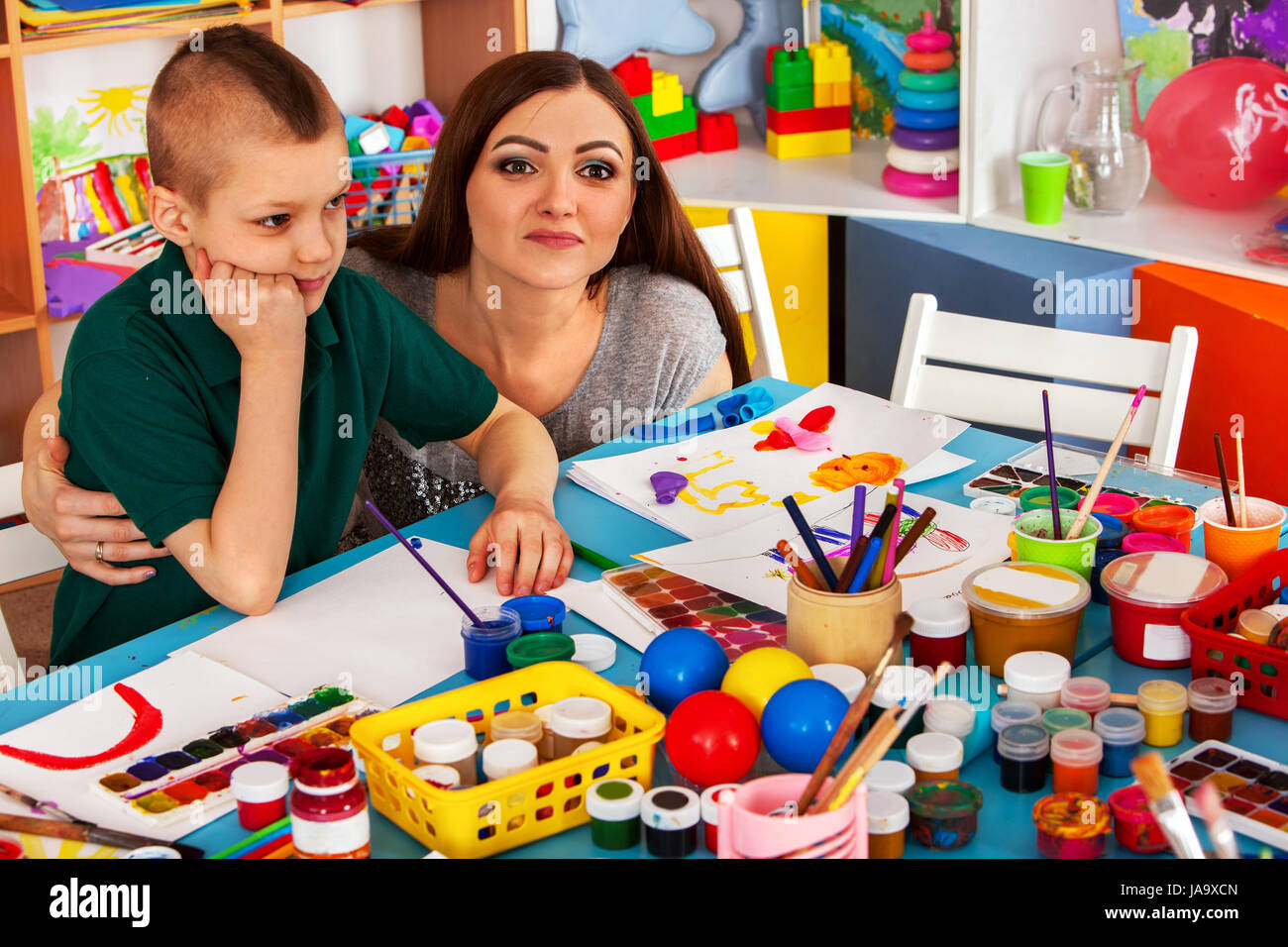 Children painting and drawing together . Craft lesson in primary school ...