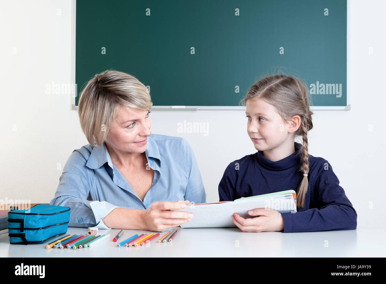 class teacher checked homework Stock Photo - Alamy